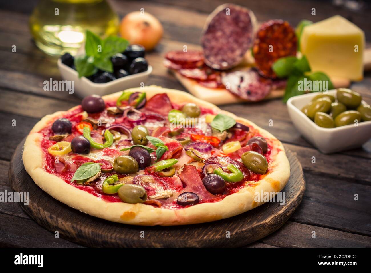 Homemade pizza with ham, cheese and vegetables Stock Photo - Alamy