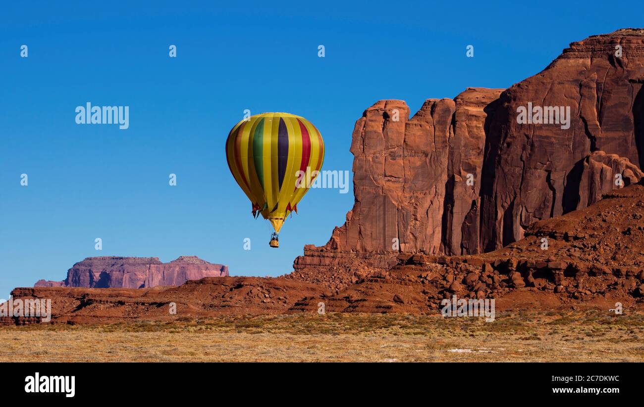 USA, Arizona, Monument Valley, A hot air balloon flying by Spearhead ...