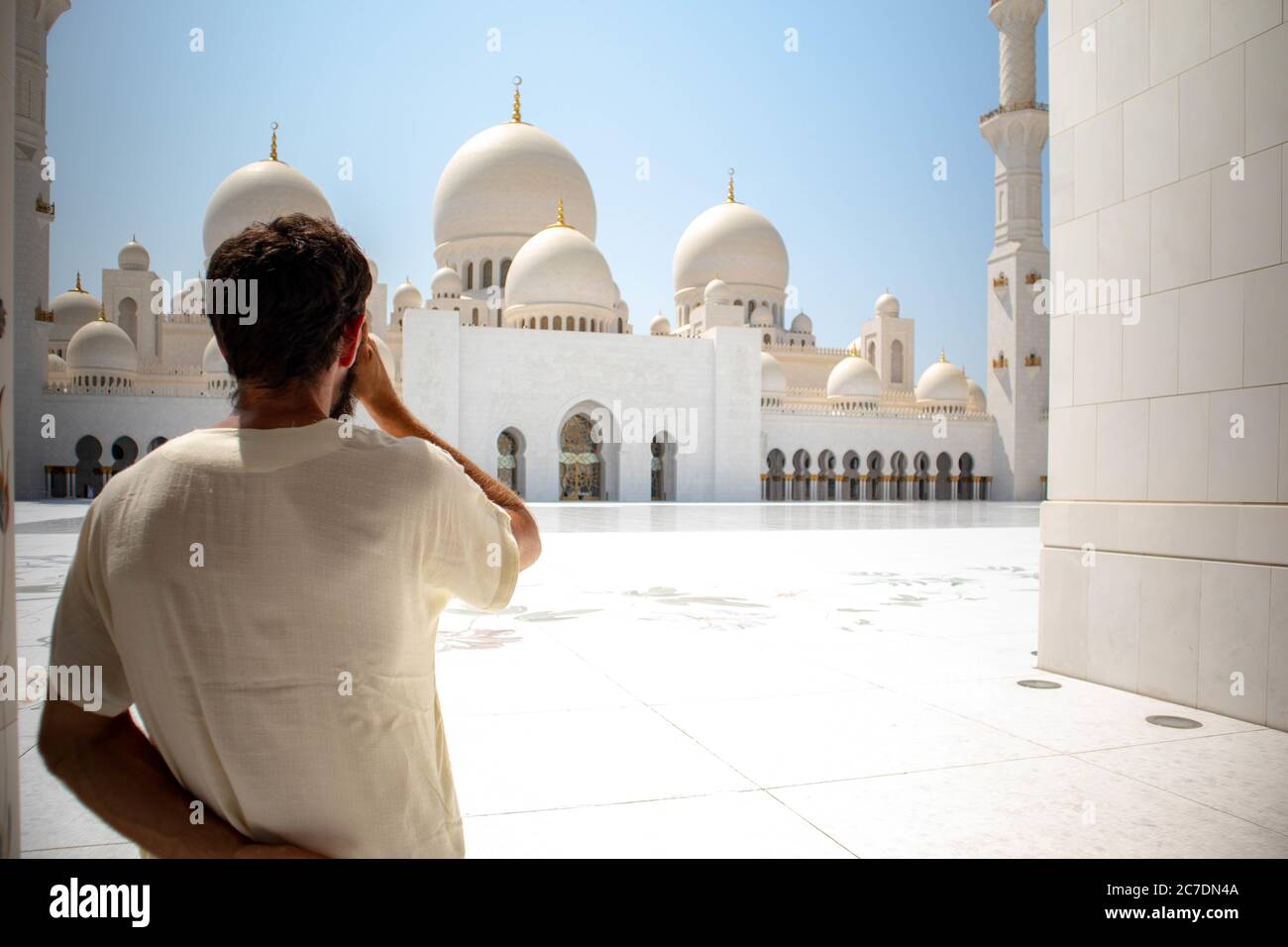 Wide shot of a person wearing white thawb standing at Sheikh Zayed ...