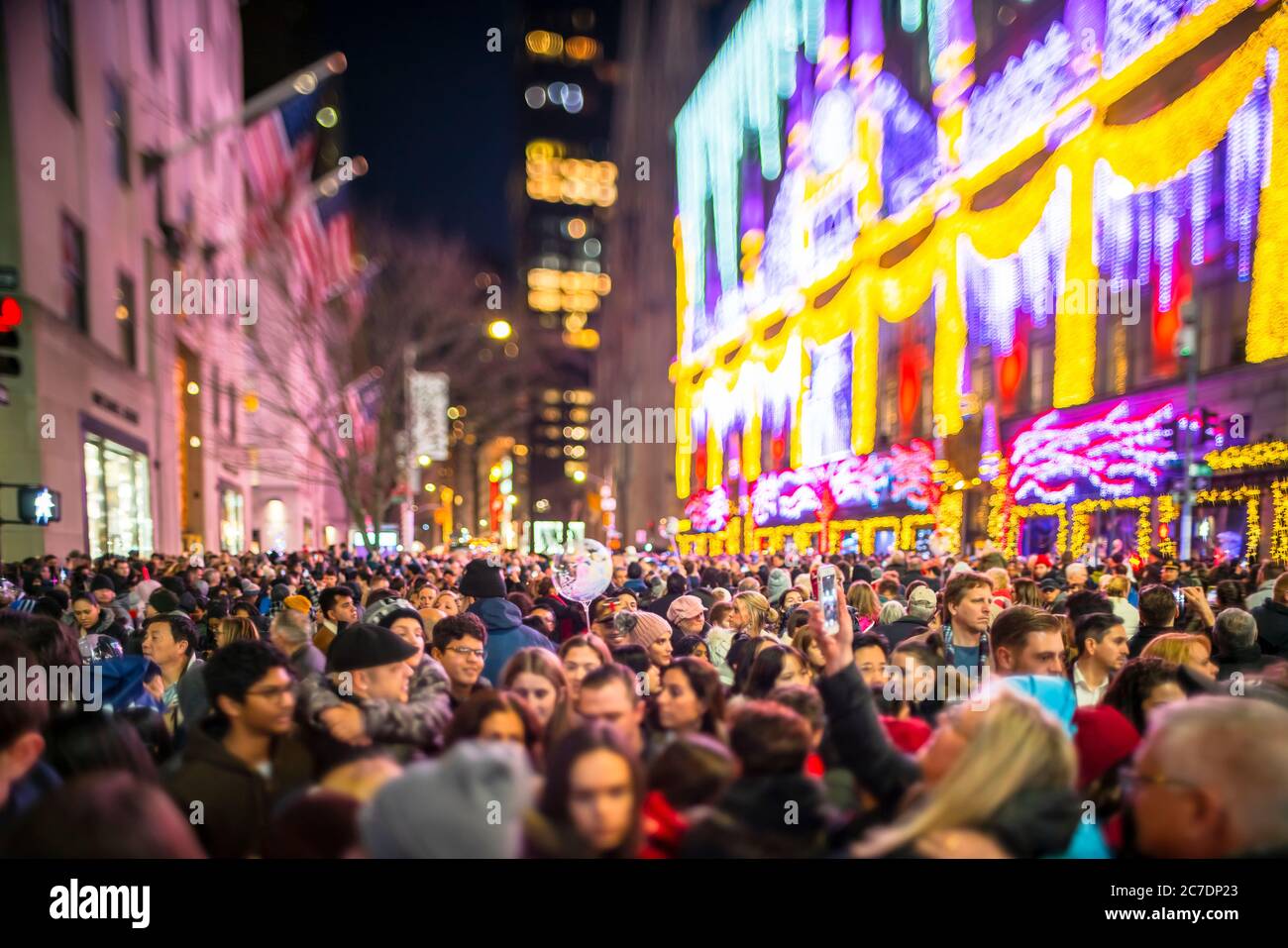 A crowd of people stays to watch the SAKS FIFTH AVENUE Christmas Light ...