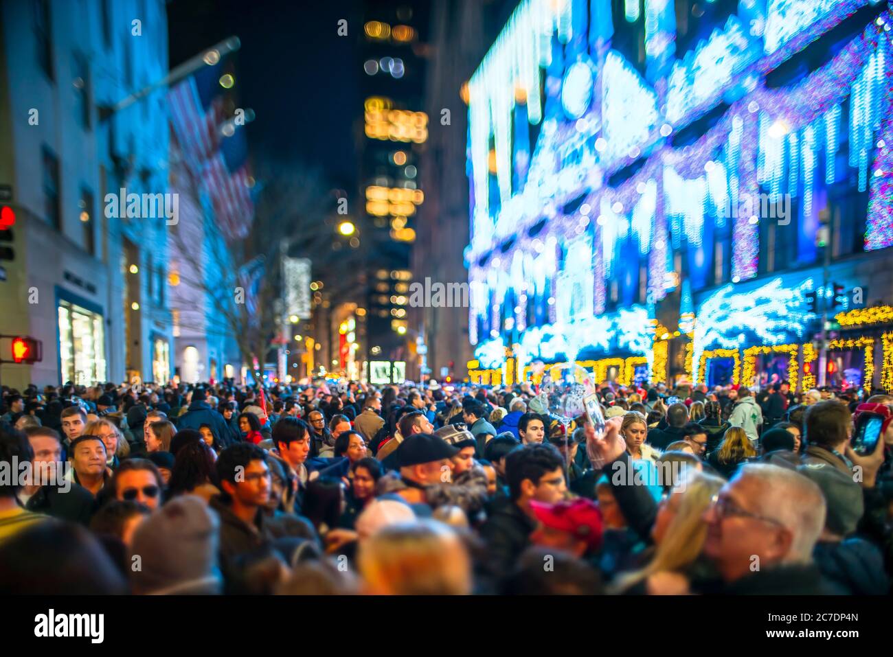 A crowd of people stays to watch the SAKS FIFTH AVENUE Christmas Light ...