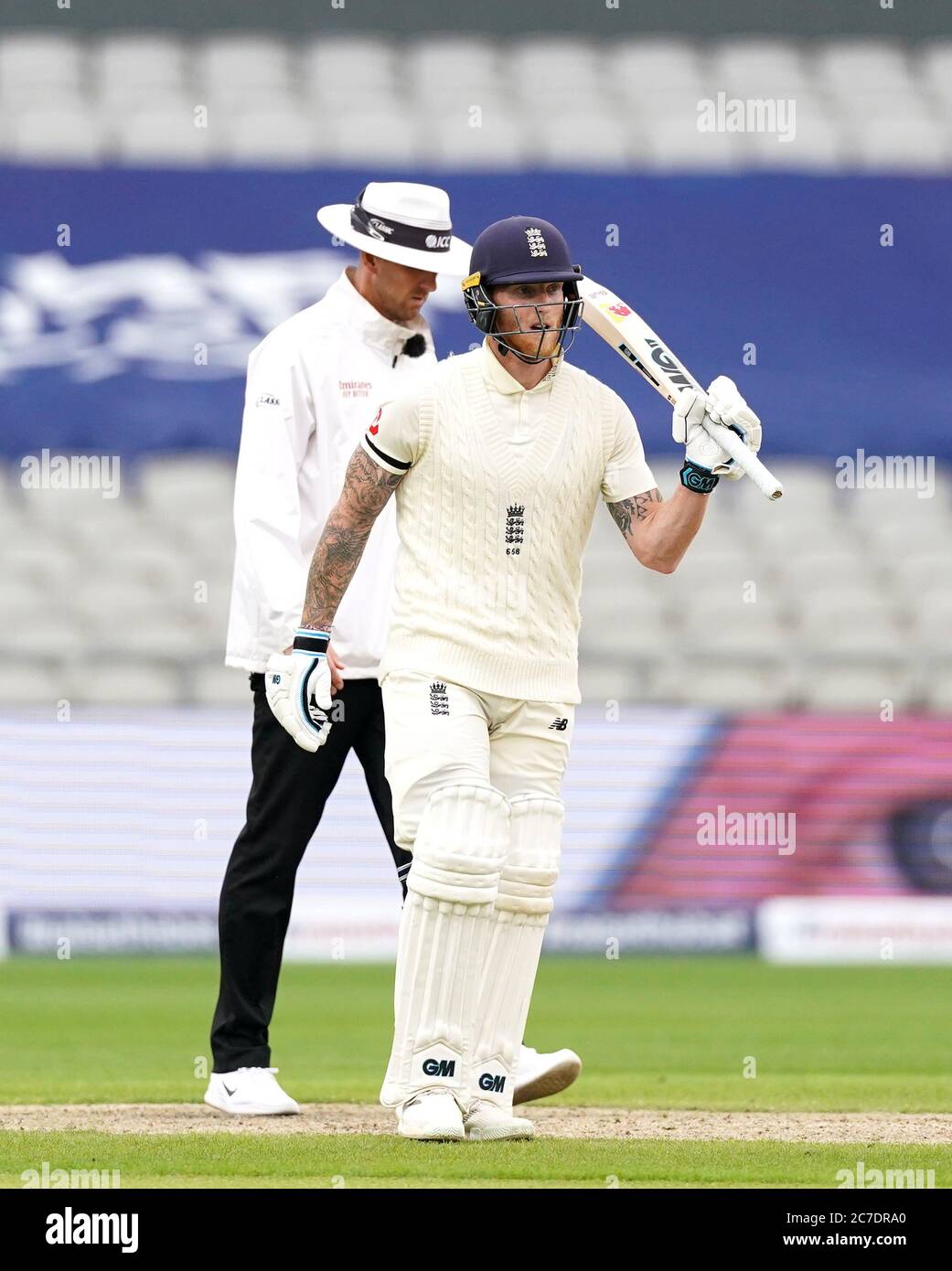 England's Ben Stokes celebrates making his half century during day one ...