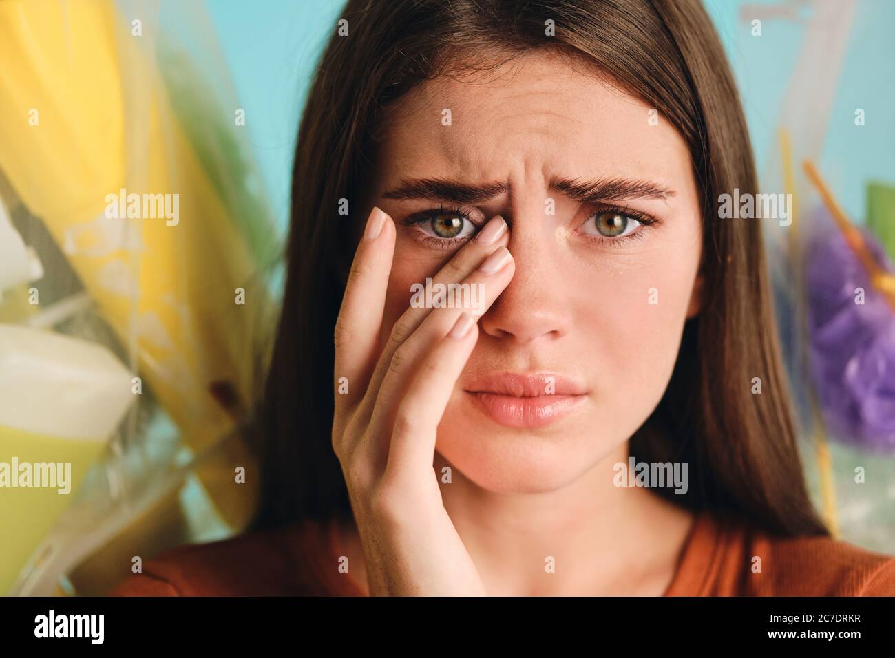 Close up crying girl near eco bags with plastic waste sadly looking in ...