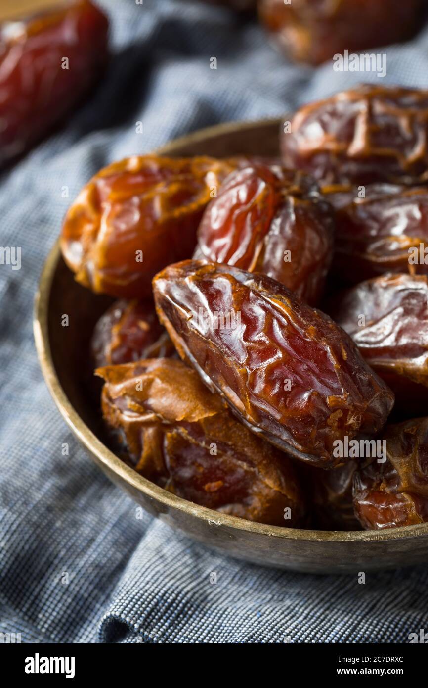 Organic Dry Red Dates in a Bowl Stock Photo - Alamy