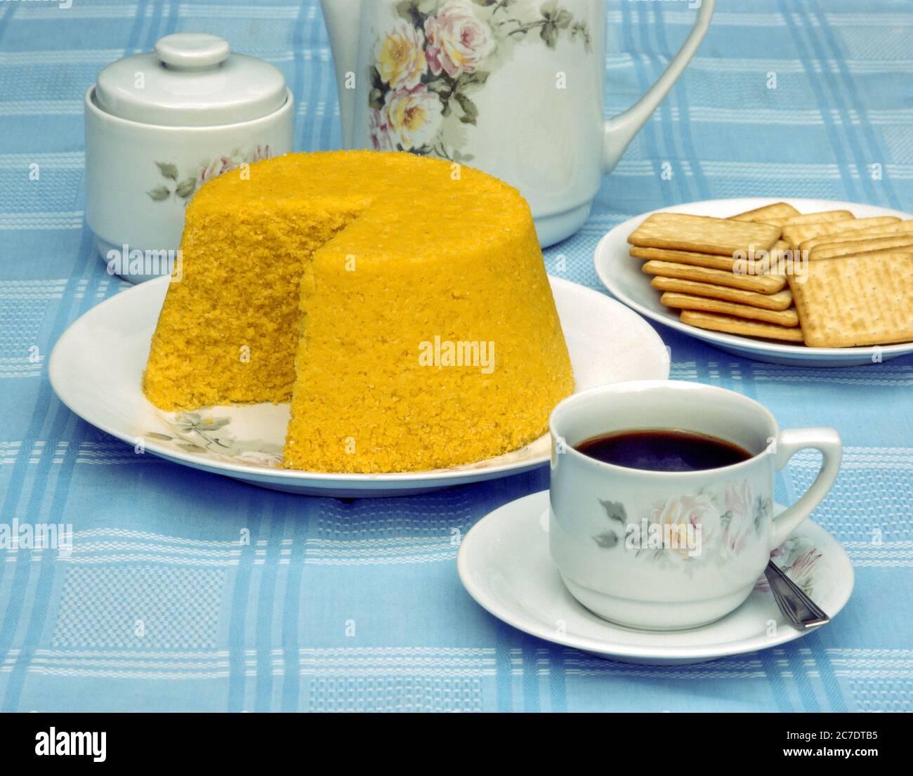 Corn couscous on the table with coffee, corn, butter and cream cracker ...