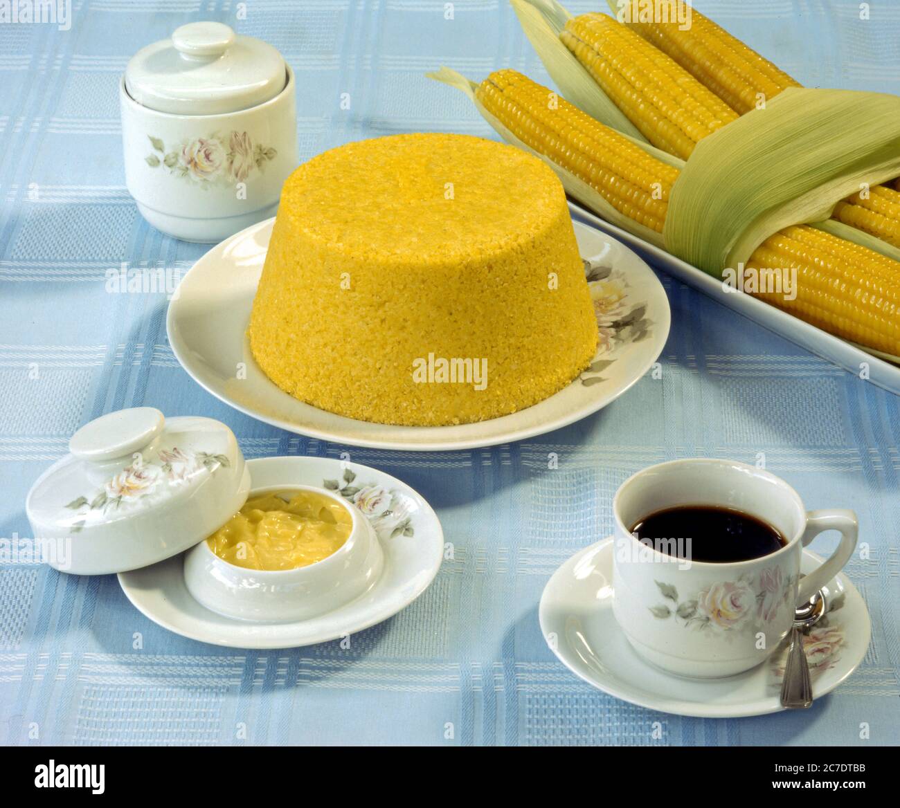 Corn couscous on the table with coffee, corn, butter and cream cracker ...