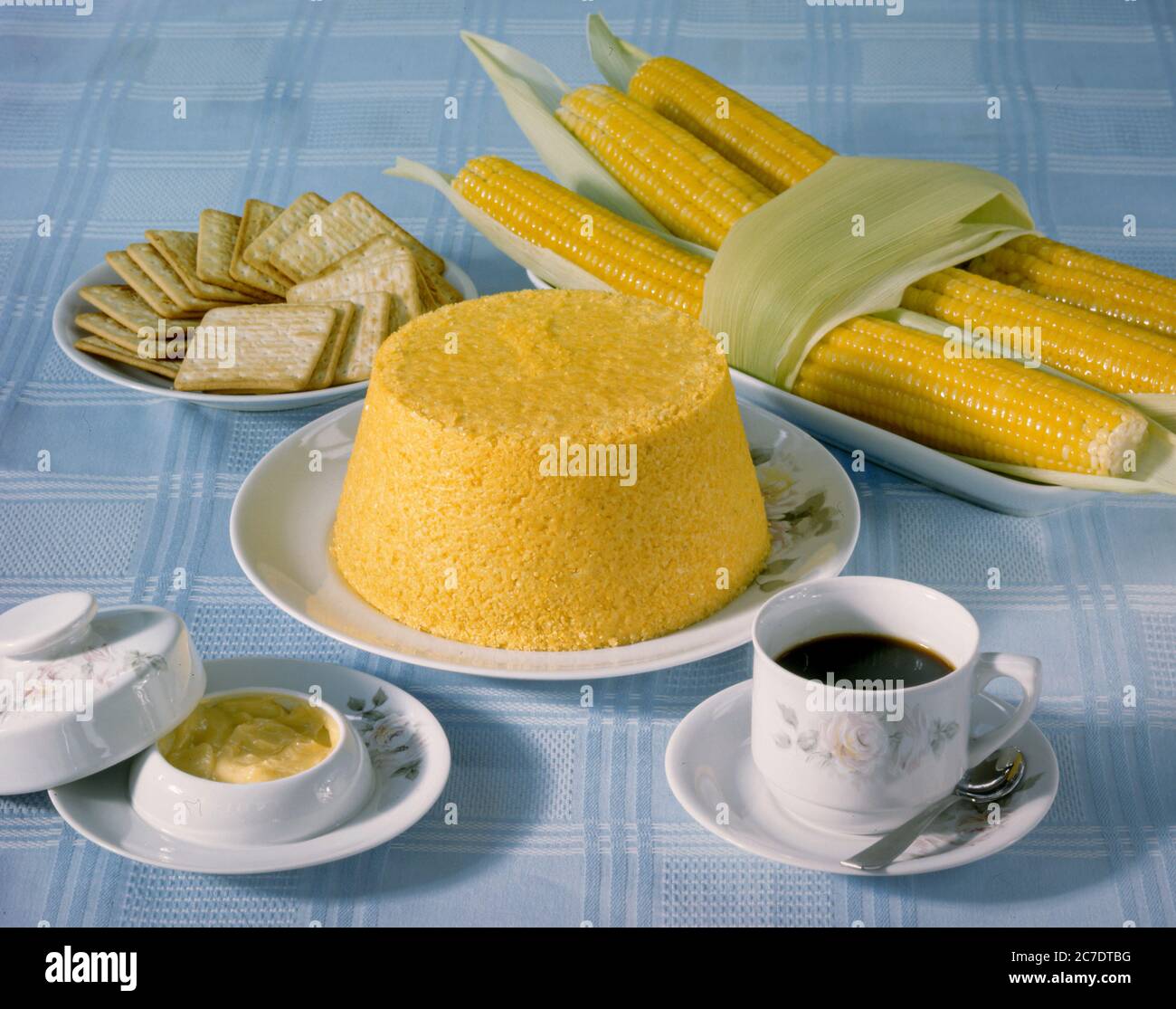 Corn couscous on the table with coffee, corn, butter and cream cracker ...