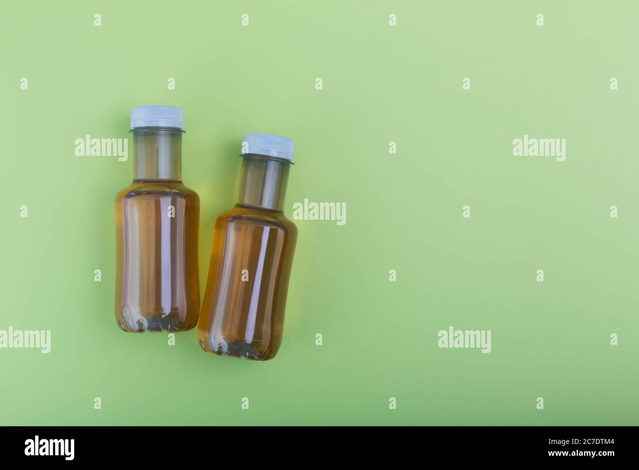 Bottles of ice tea, top view, green background Stock Photo - Alamy