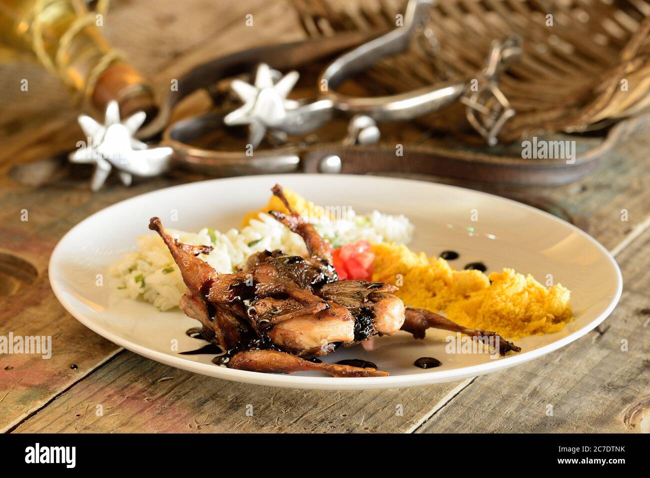 Gastronomy. Fried quail with rice and manioc flour. Traditional dish of ...