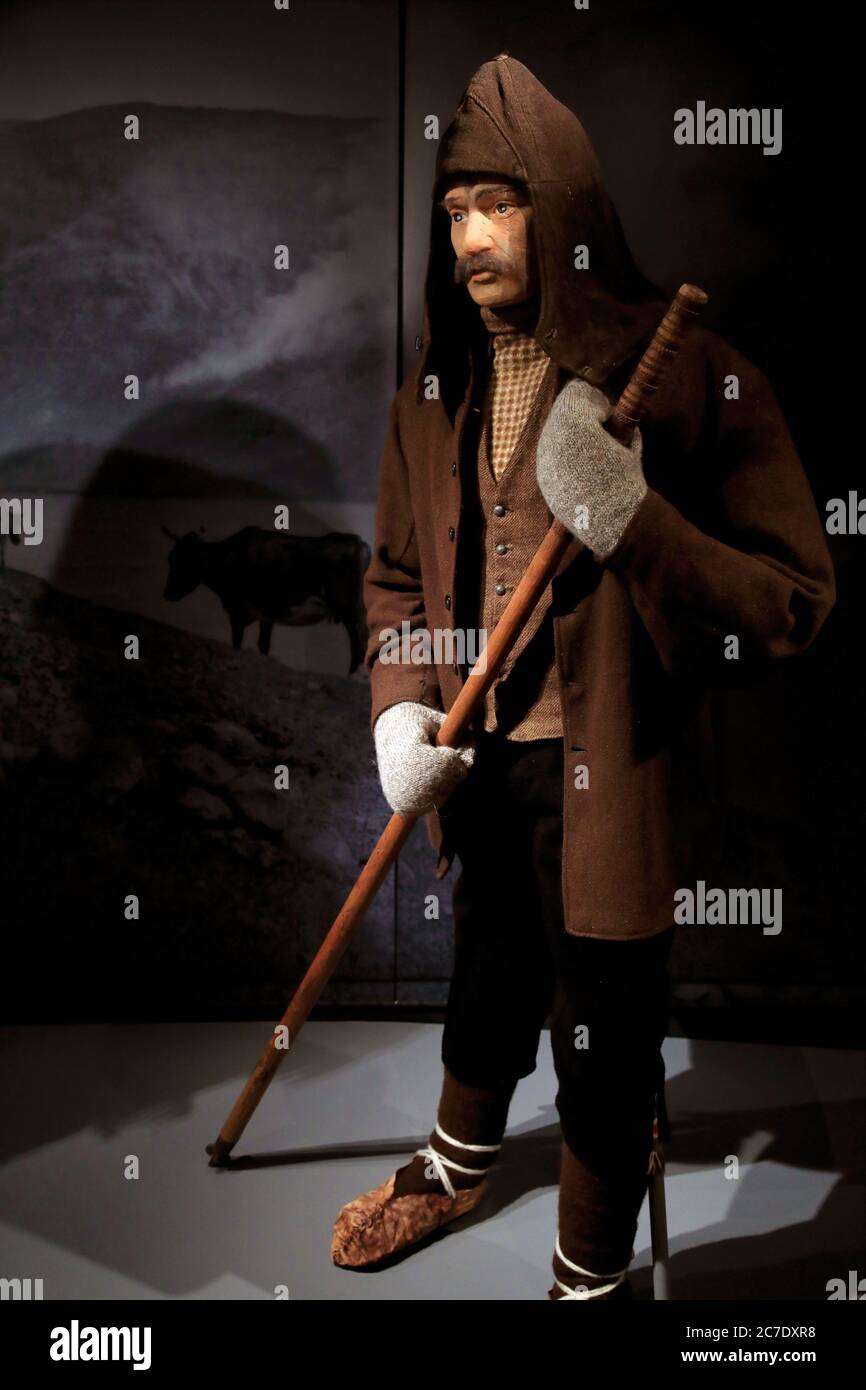 Traditional winter male working clothes with wool mittens on a minikin ...