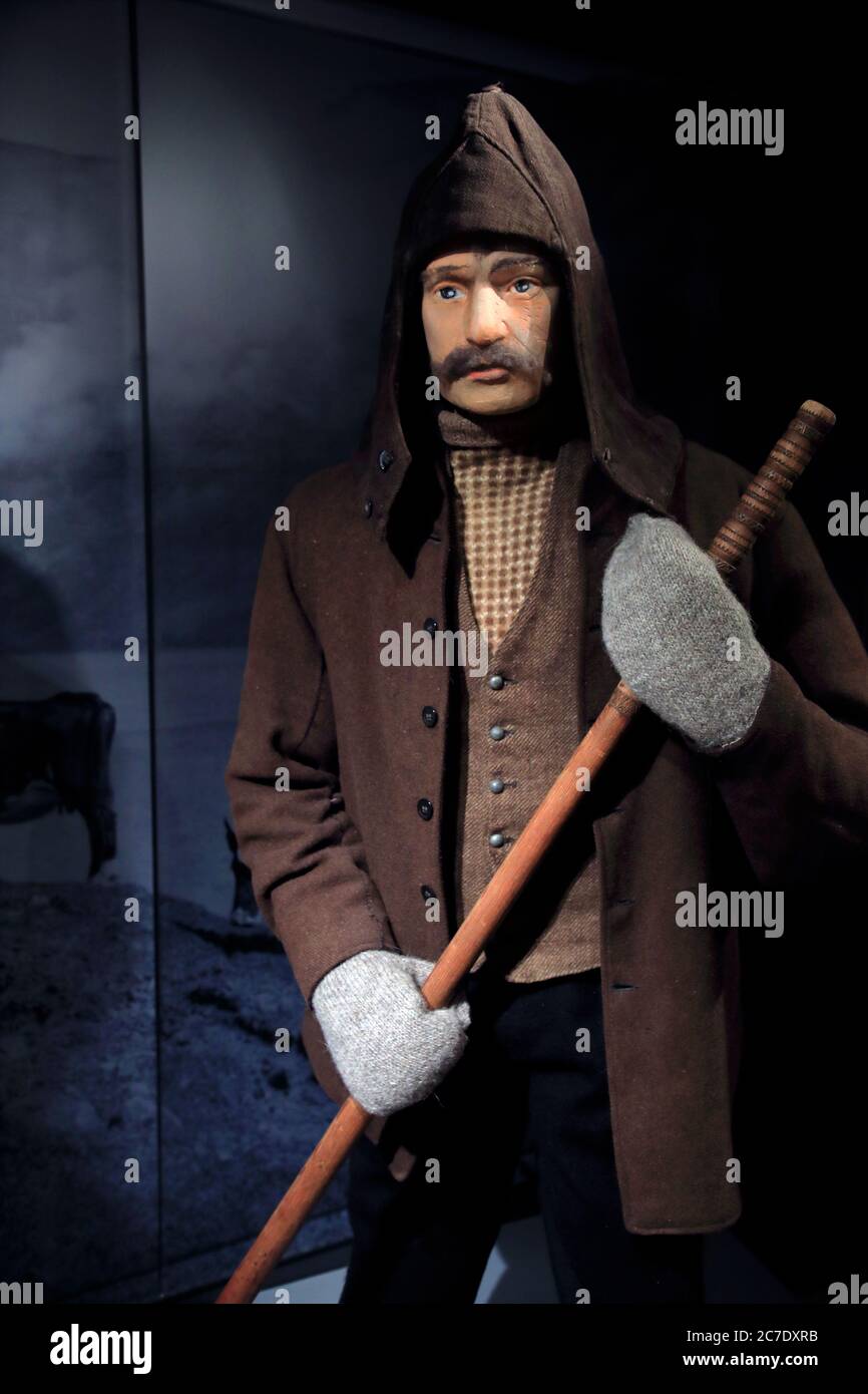 Traditional winter male working clothes with wool mittens on a minikin ...