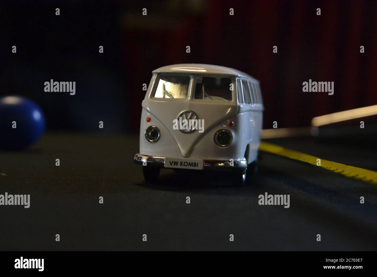 White iron minivan. Front detail with headlight, windshield and logo ...