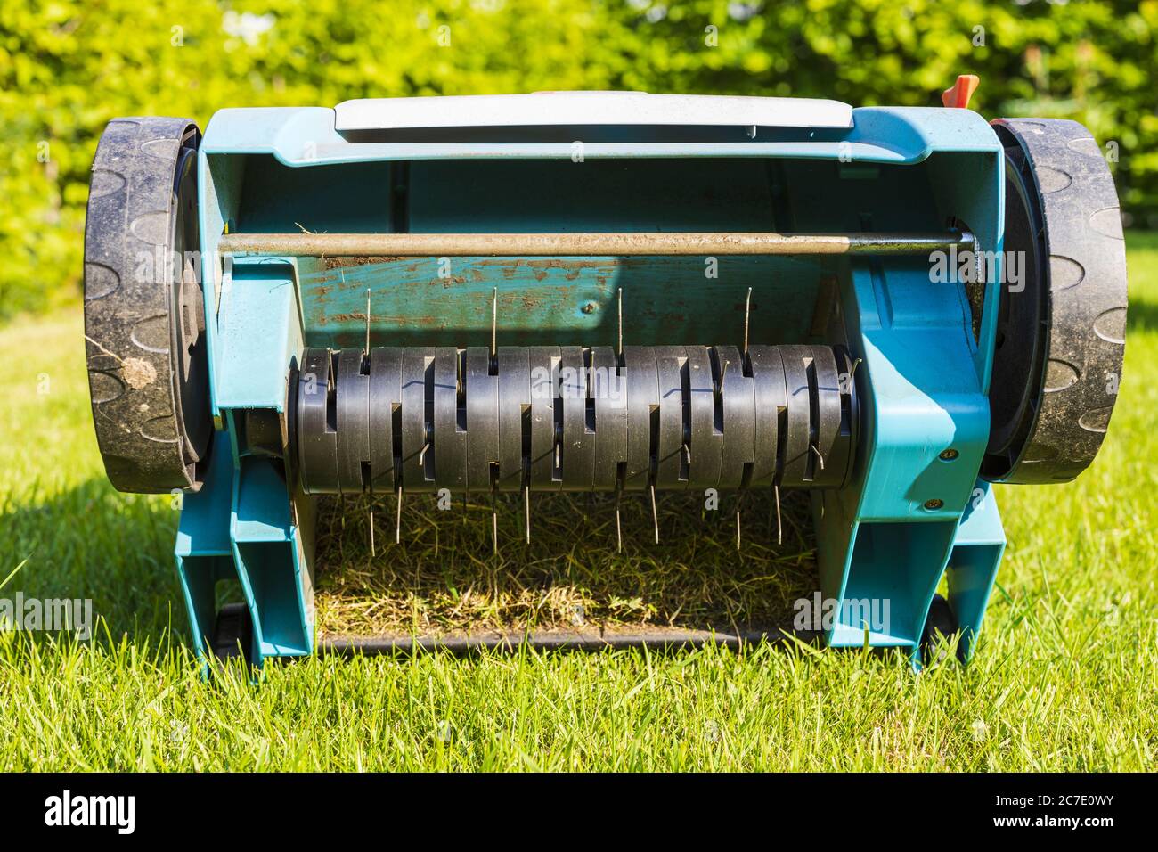 Close up view of electric lawn aerator on green grass isolated. Garden ...