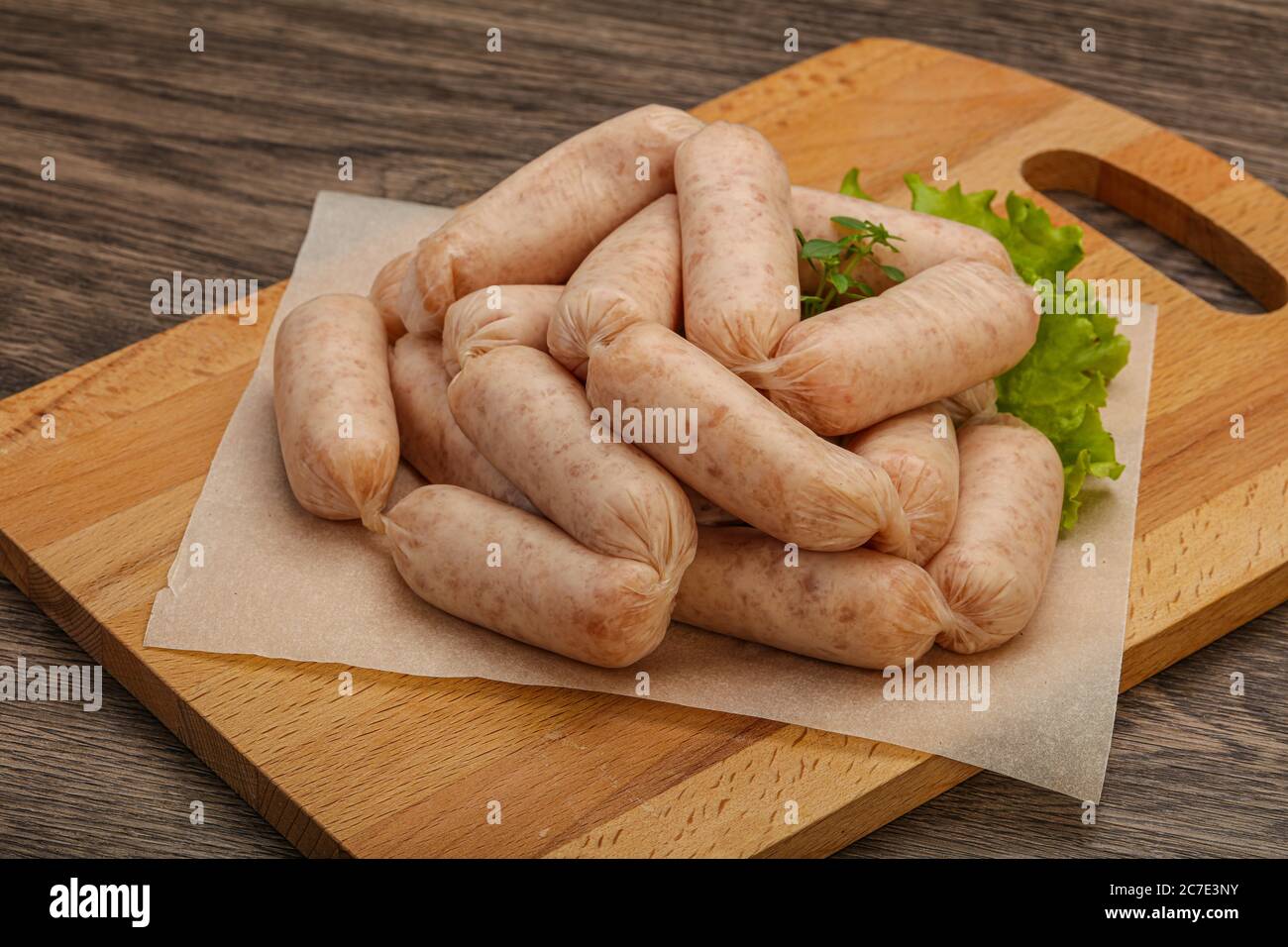 Raw natural chicken baby sausages for roast Stock Photo - Alamy