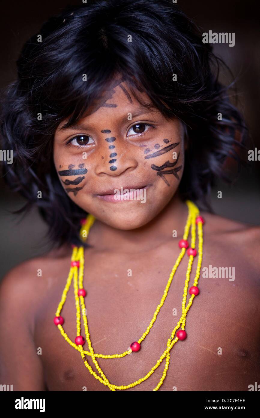 Portrait of an Amazonian indigenous child with traditional face paint ...