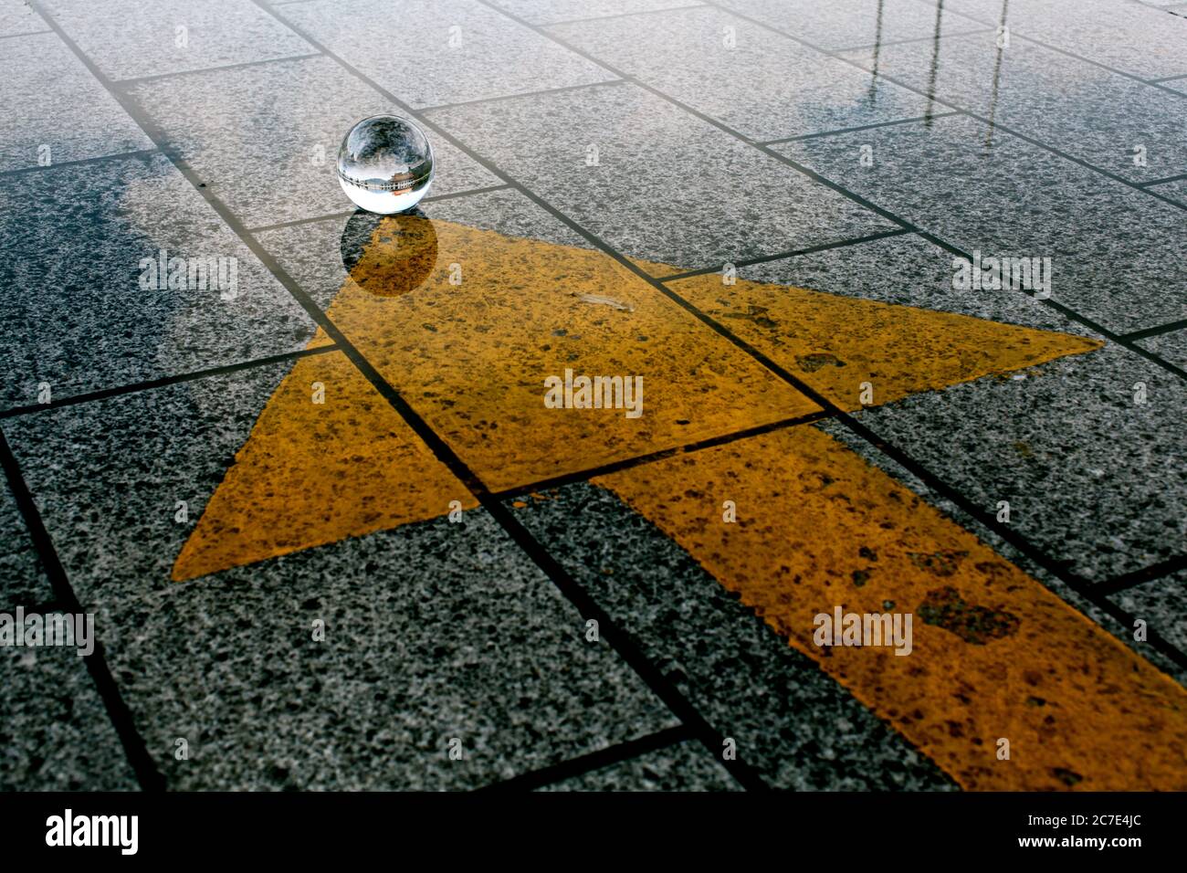 High angle shot of the stone ground with a yellow arrow pointing ...