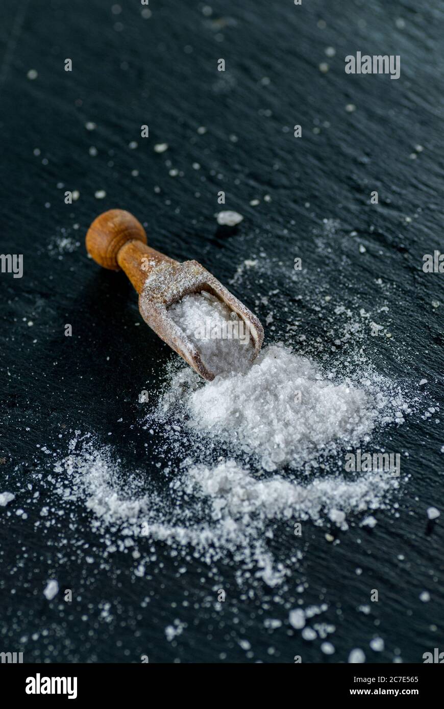 measure cup with salt and salt spread on black slate concept Stock ...