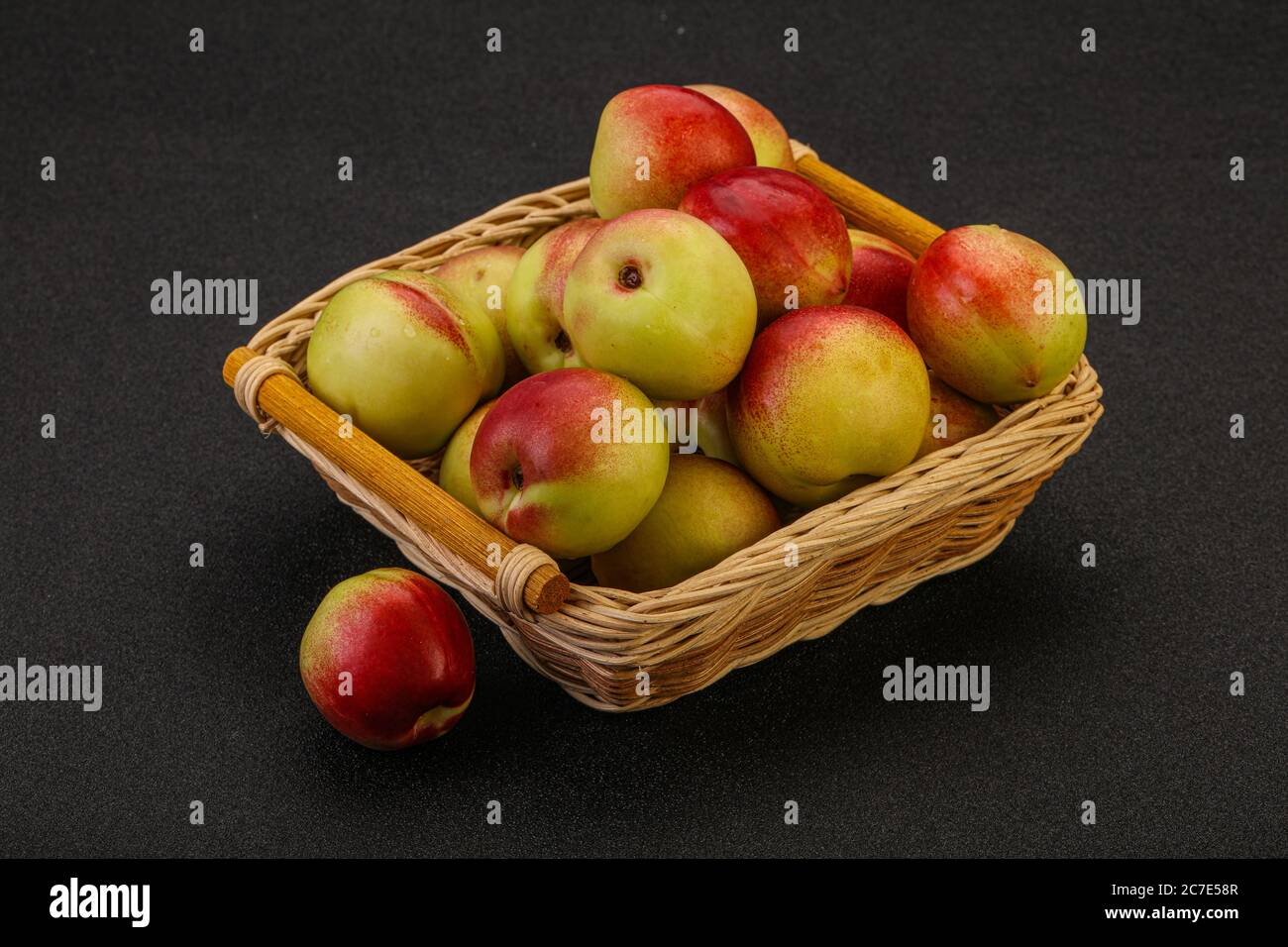 Sweet small green nectarines in the basket Stock Photo - Alamy