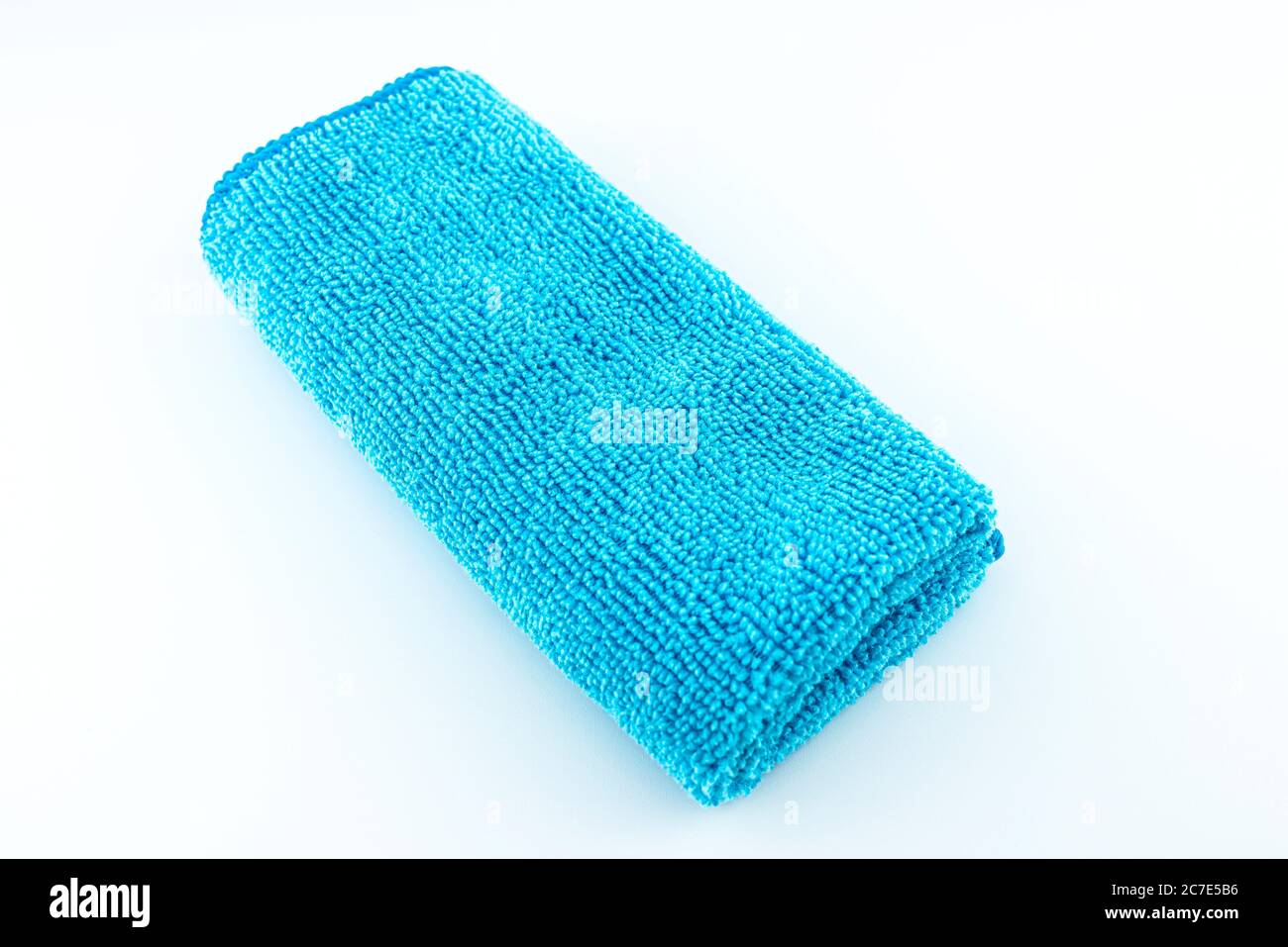 Light blue microfiber fabric lying in the middle, isolated on a white ...