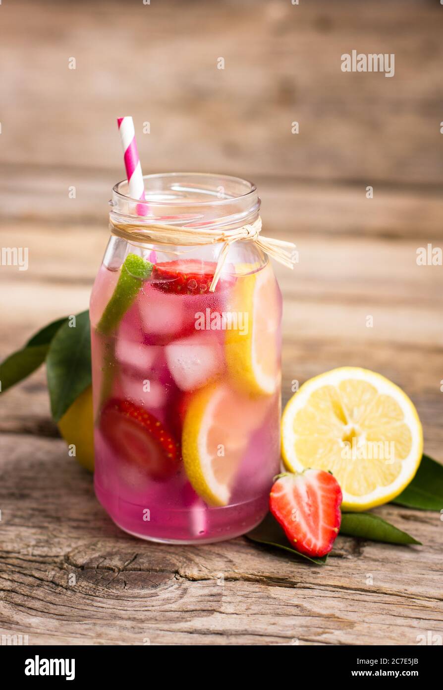 Homemade fresh pink lemonade with lemon, lime and strawberries Stock ...