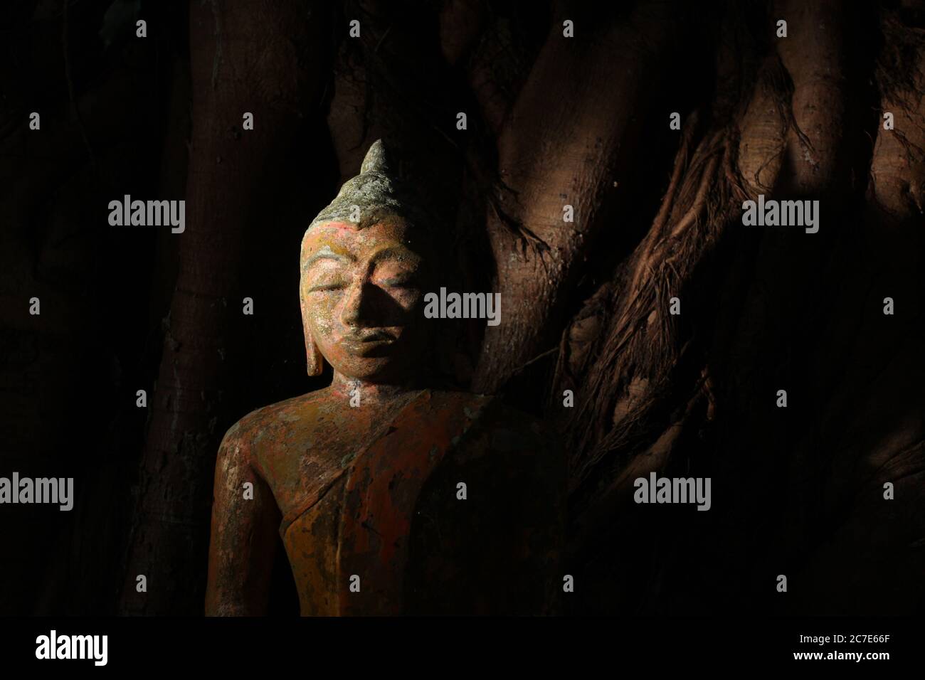 Closeup shot of a clay religious Buddha statue in a creepy mysterious ...