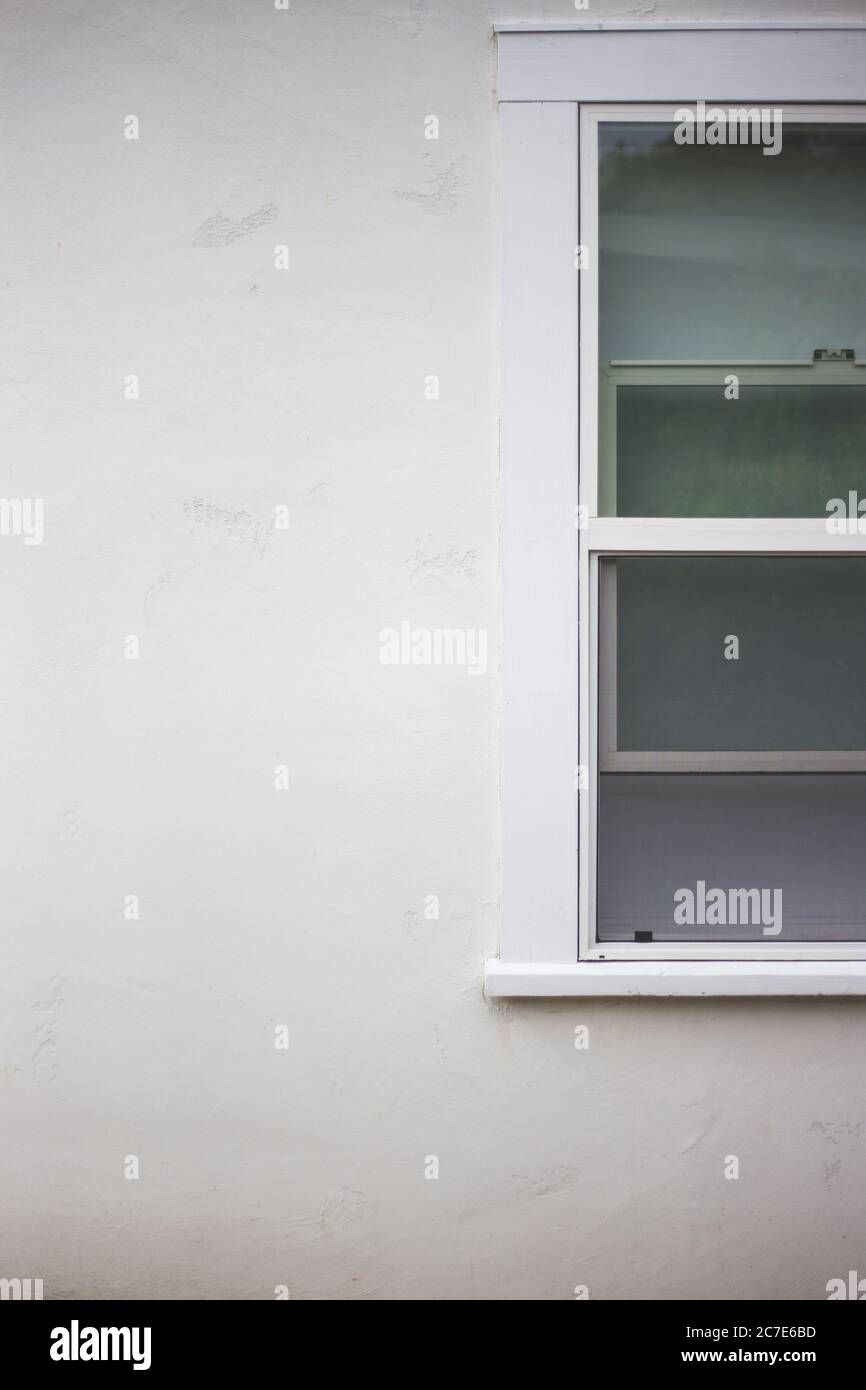 Vertical shot of a modern white building wall with a white window ...