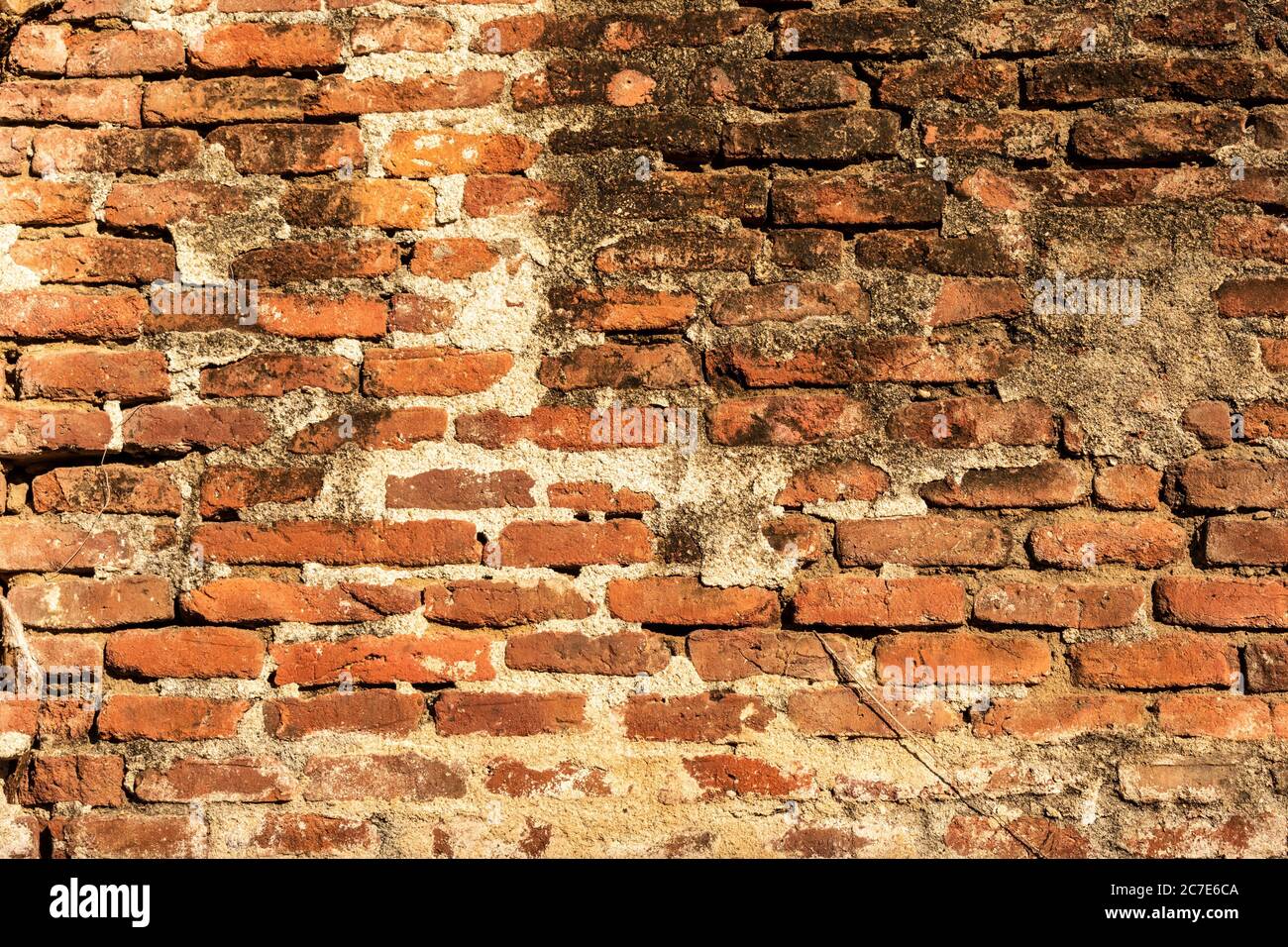 Red brick wall background with uneven masonry Stock Photo - Alamy