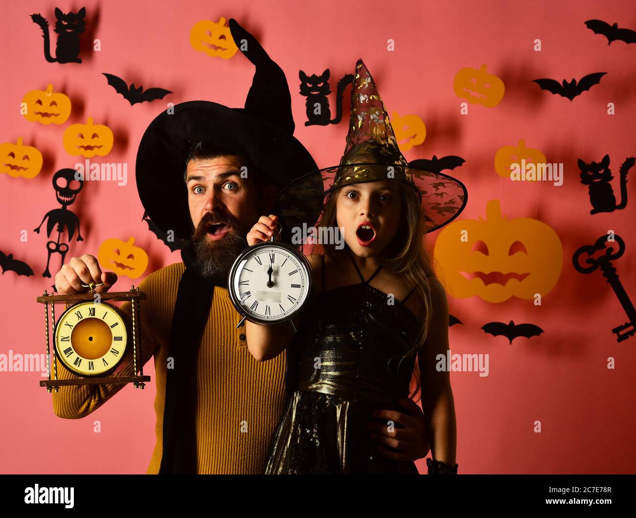 Halloween party and celebration concept. Girl and bearded man with ...
