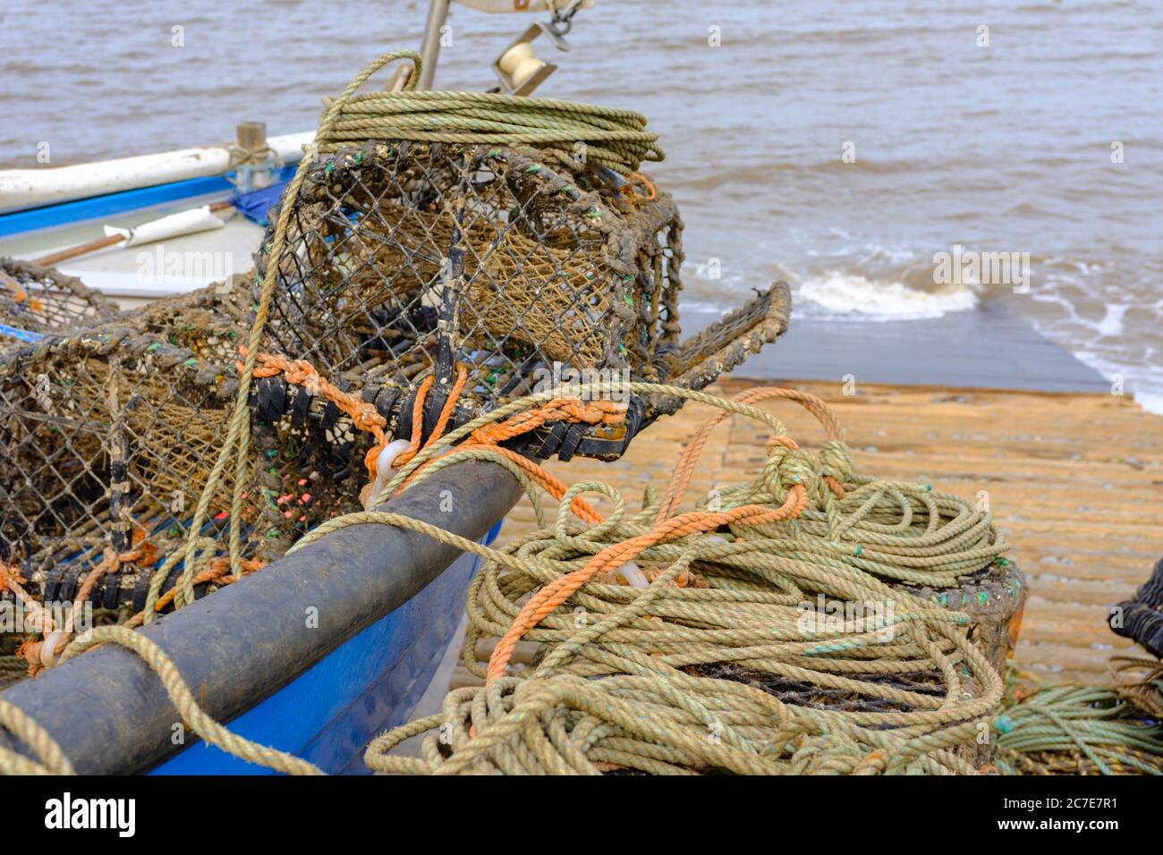 Lobster pots, crab pots, fishing tackle alongside the sea shore ...
