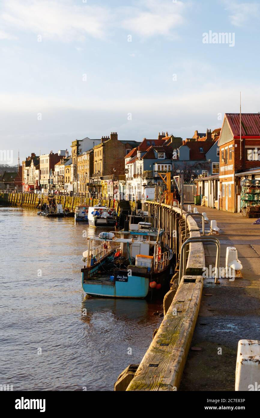 Winter sunrise over Whitby fishing harbour, England, UK Stock Photo - Alamy