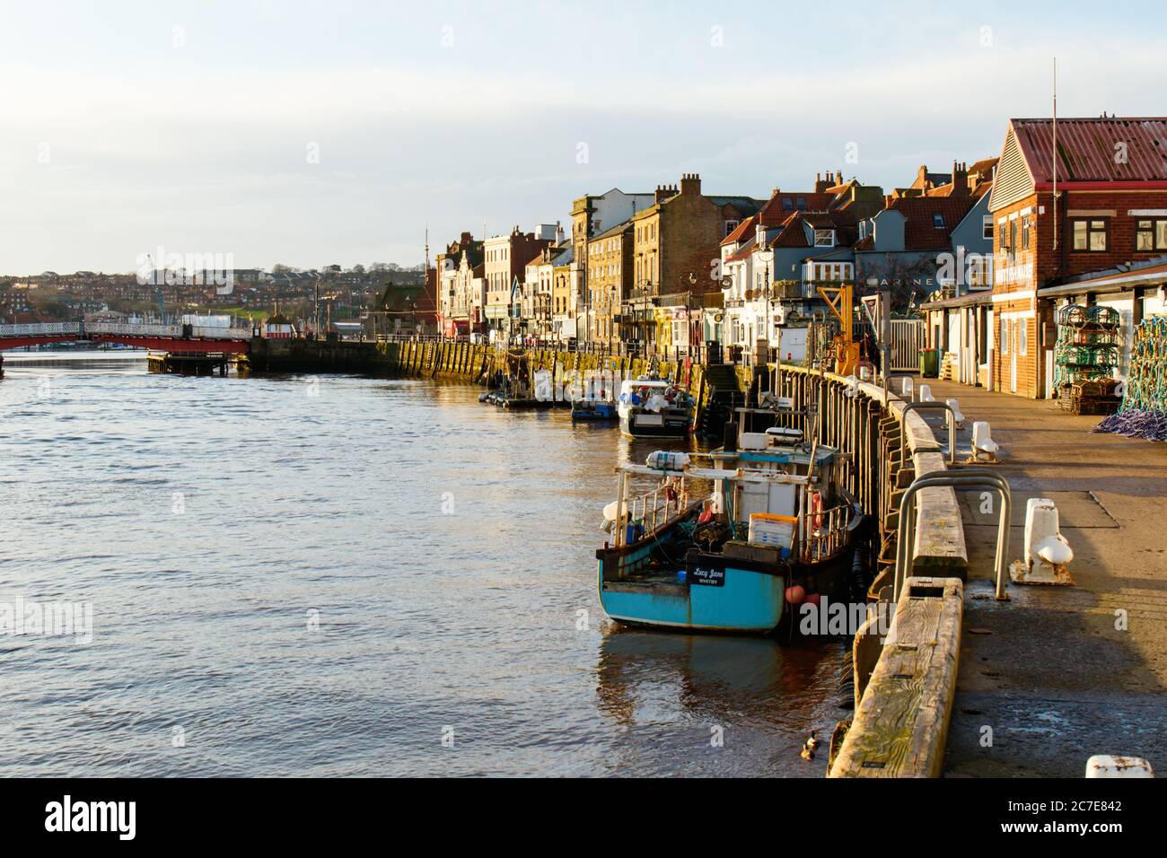 Winter sunrise over Whitby fishing harbour, England, UK Stock Photo - Alamy