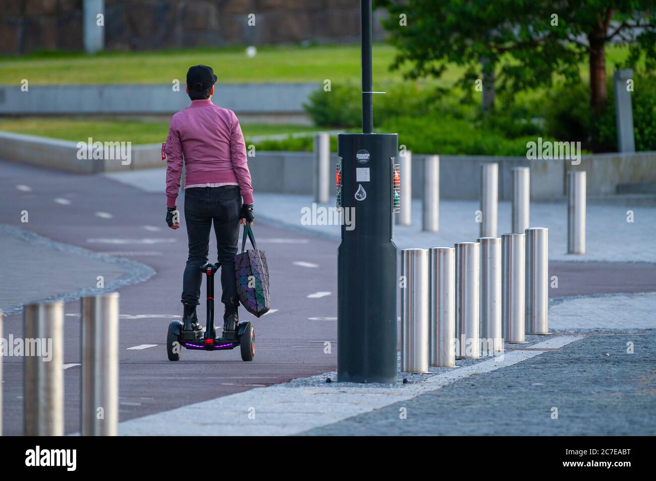 A person riding with electric scooter on a bicycle lane Stock Photo - Alamy