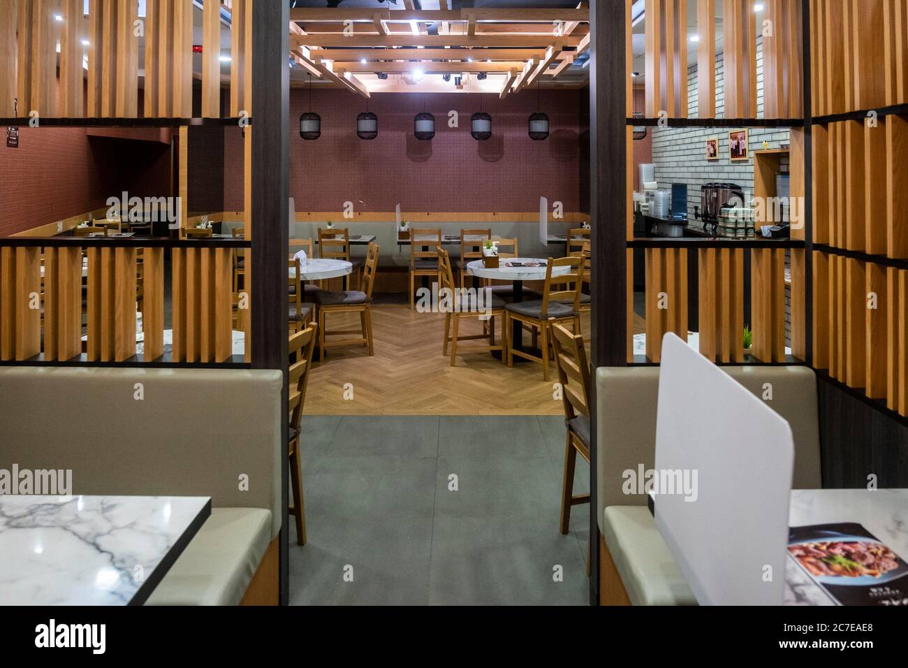 A view of an empty restaurant with social distancing screens displayed ...