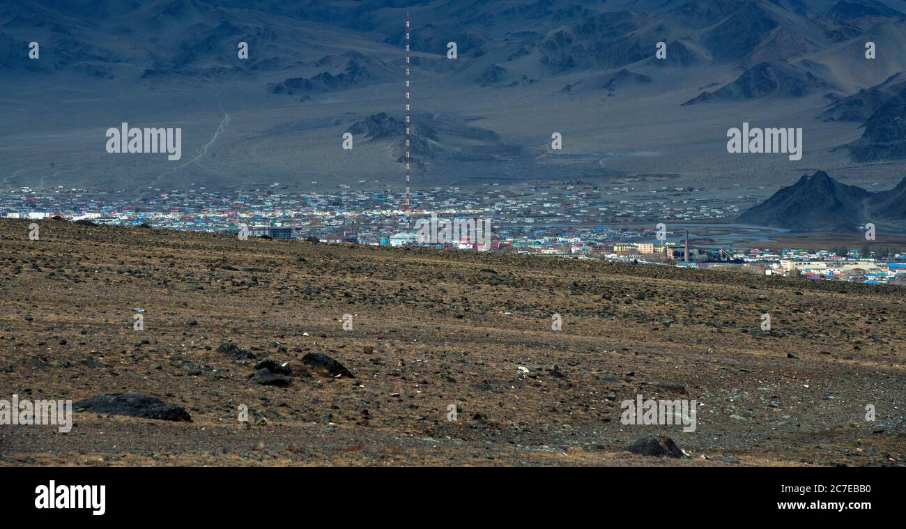 A communications tower dominates the skyline of the city of Olgii ...