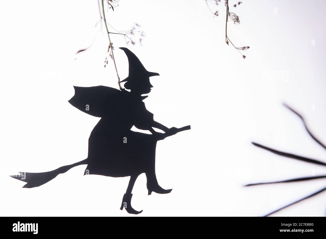 Witch of paper flying on her broom to Sabbath, on a white background ...