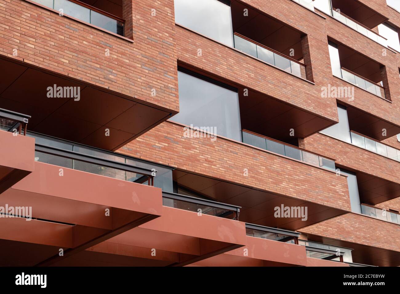 Texture view of beautiful red bricks modern building with large windows ...