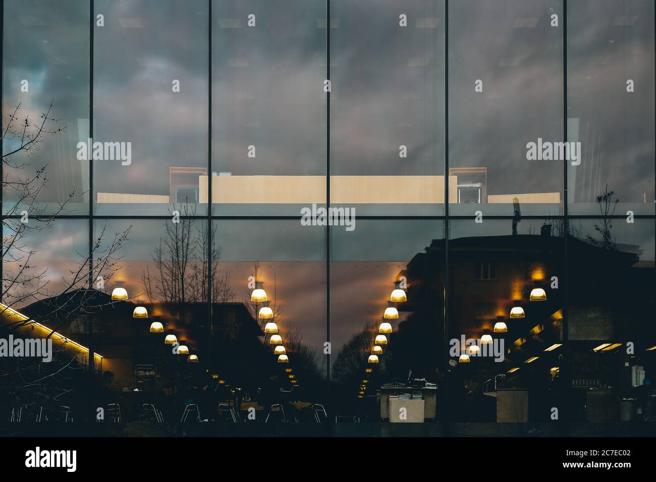 Horizontal shot of the reflection of street lights from the windows of ...