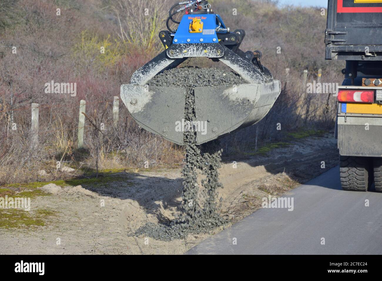 Heavy road machine when repairing damaged road surface. In the sun ...