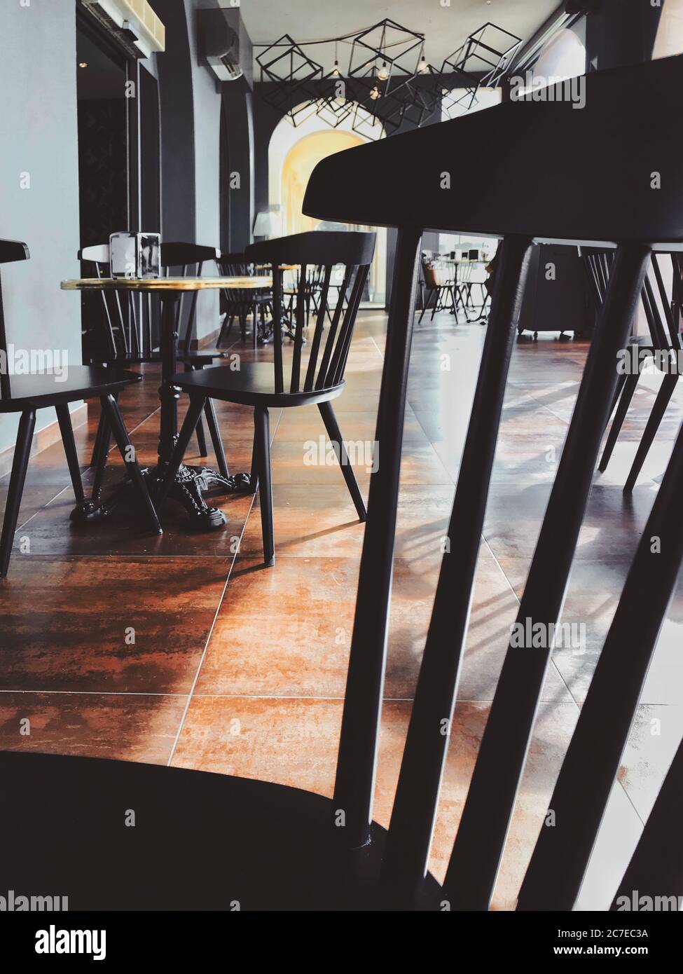 Vertical shot of an empty cafe with beautiful decorations and black ...
