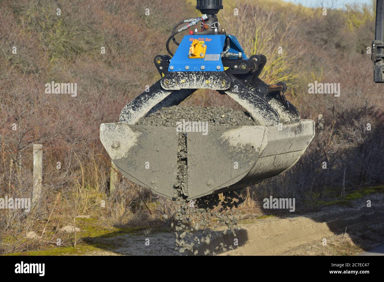 Heavy road machine when repairing damaged road surface. In the sun ...