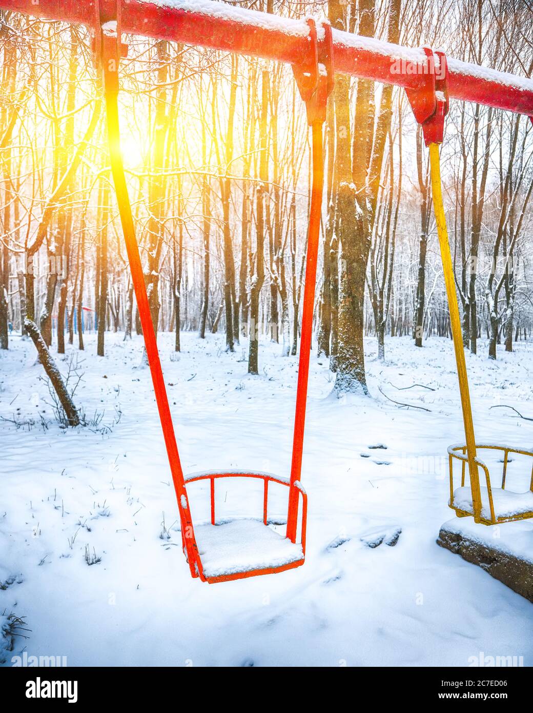 Empty swing in winter time with snow. Children's swing under a thick ...