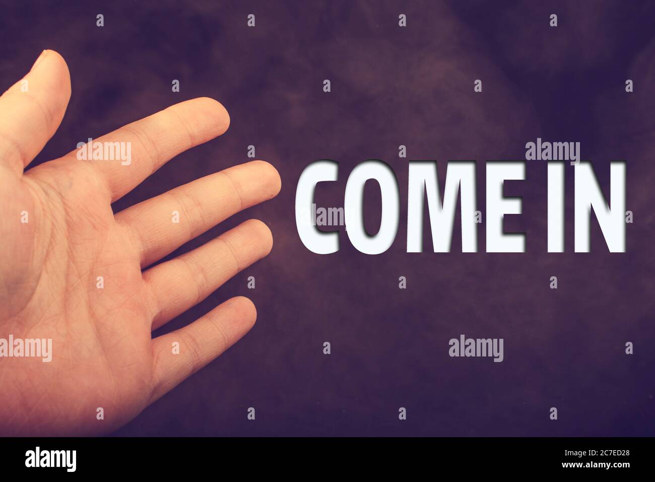 Hand making welcome gesture saying come in Stock Photo - Alamy