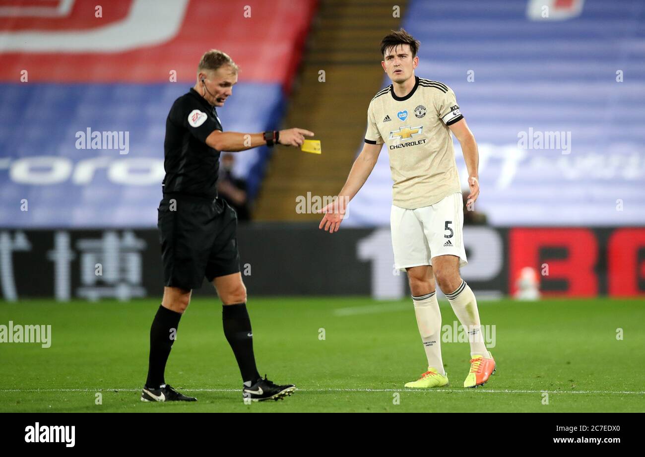 Referee Graham Scott shows Manchester United's Harry Maguire the yellow ...