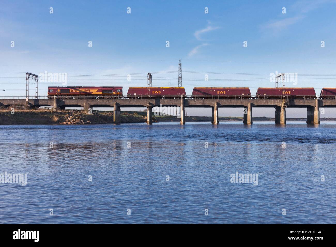 DB cargo Rail / EWS class 66 locomotive crossing the metal bridge ...