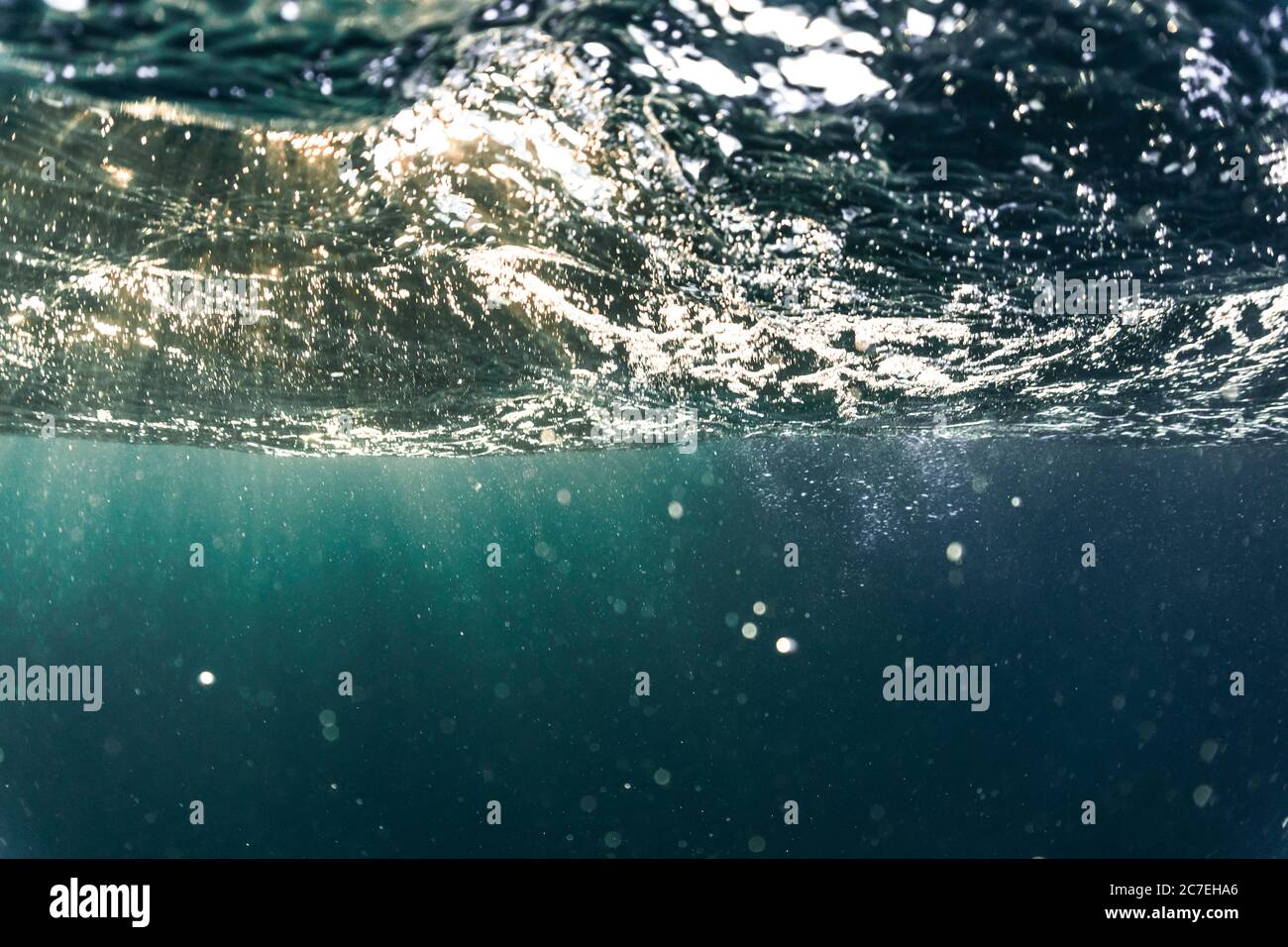 Rays of light shining through the surface of the atlantic ocean, into ...