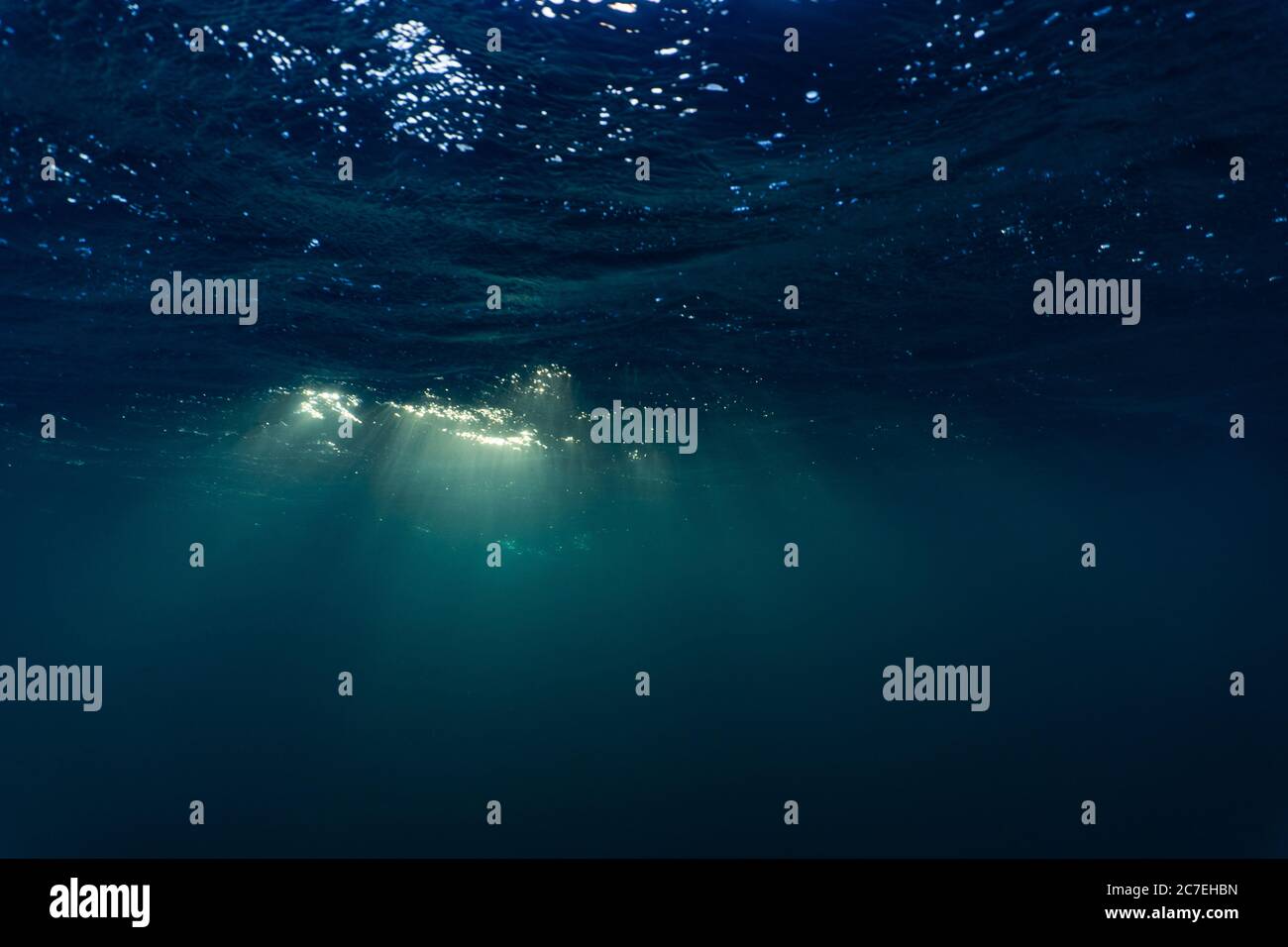 Rays of light shining through the surface of the atlantic ocean, into ...