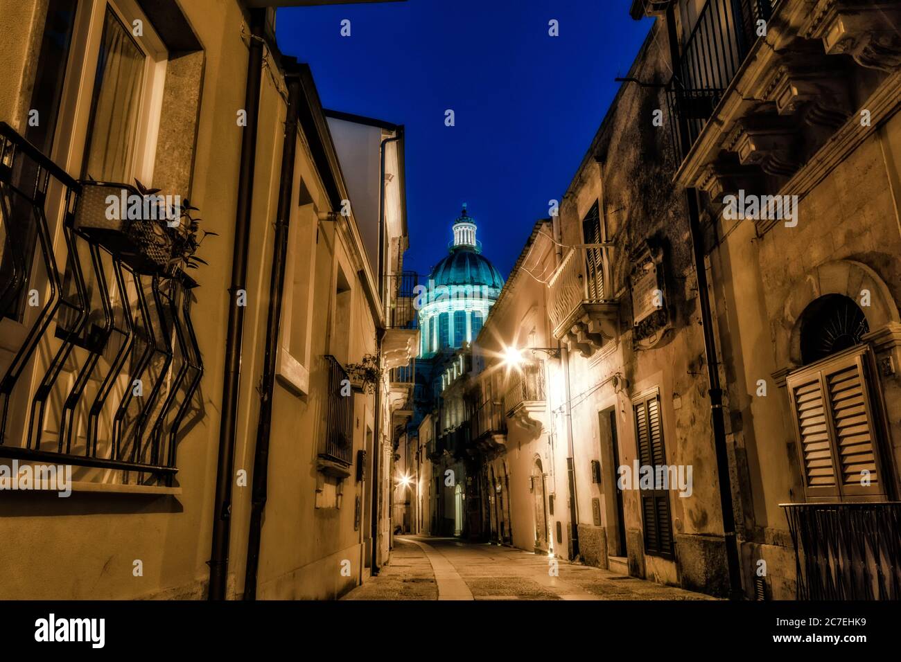 Horizontal shot of a narrow street in a nice neighborhood and a dome of ...