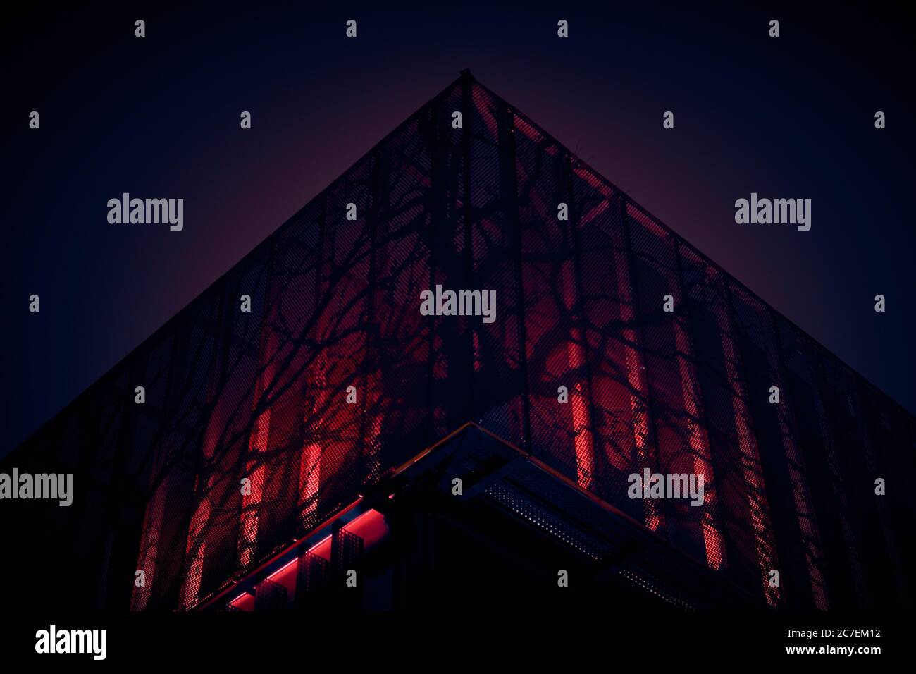 Low angle shot of an abstract modern building with tree drawings and ...