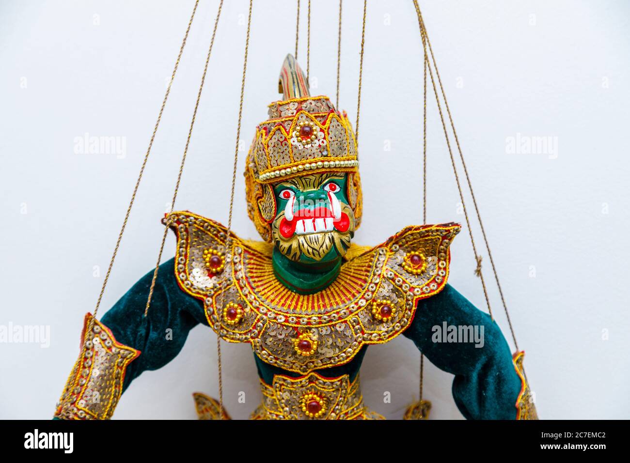A traditional large green fearsome demon wooden puppet on strings, a ...