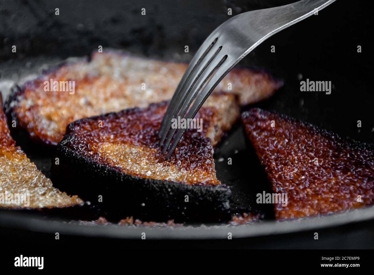 Fried in oil crunchy bread pieces. Cooking process Stock Photo - Alamy